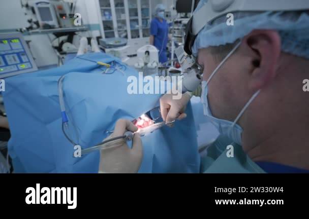 Operation of removing tonsils under deep anesthesia, surgeon uses ...