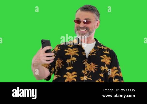 Positive funny funky old man making selfie on a Green Screen, Chroma ...