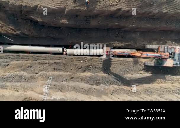 Hydraulic excavator installing pipeline Stock Videos & Footage - HD and ...