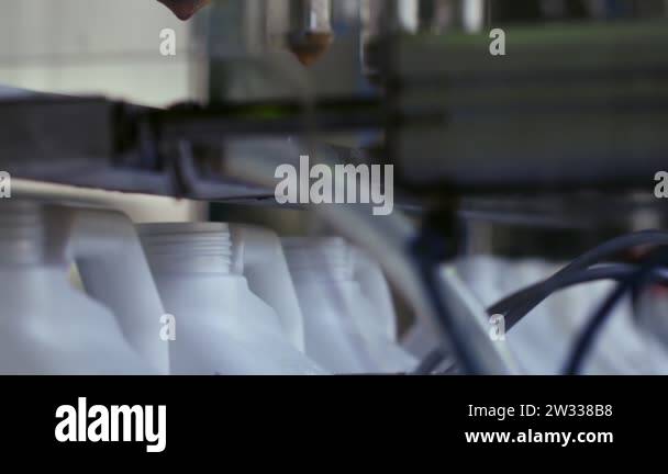 Filling plastic bottle on the conveyor. Clip. High technology Plastic ...