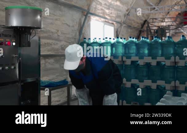 Pure water plant, men in special uniforms and protective masks work ...