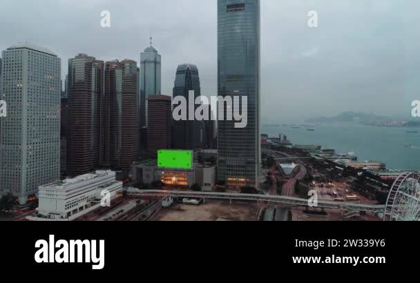 AERIAL. Top view of skyscrapers and green screen build board with ...
