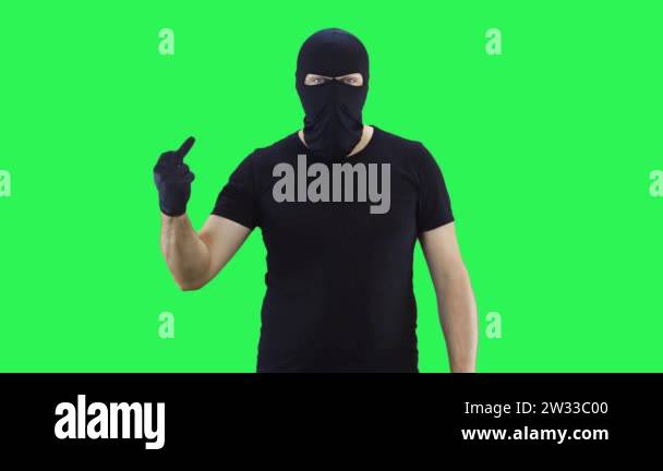 Man in balaclava shows middle finger.,green screen background Stock ...