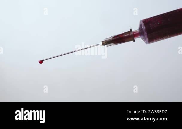 Medical syringe with blood isolated on white background. Blood drops ...