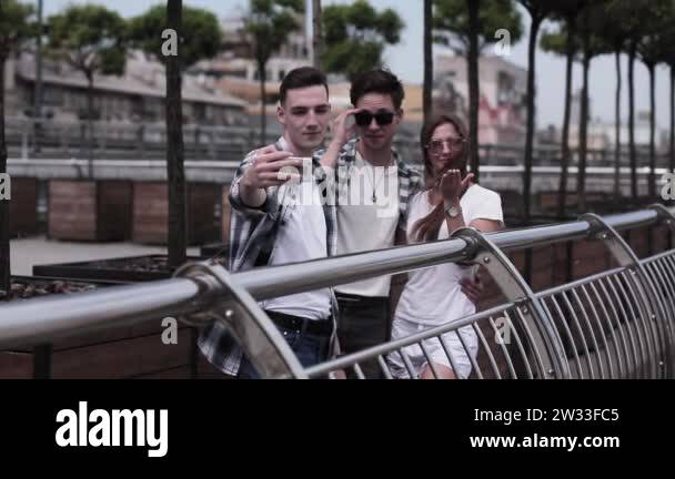 Young friends traveling in different cities of the country take selfies ...