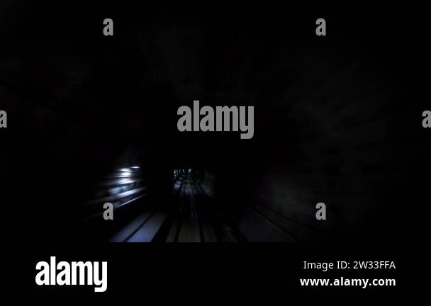 4K, Modern subway train riding fast in a dark underground tunnel at ...