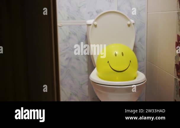 Balloon, emoticon sits on the toilet. The concept of bloating, diarrhea ...