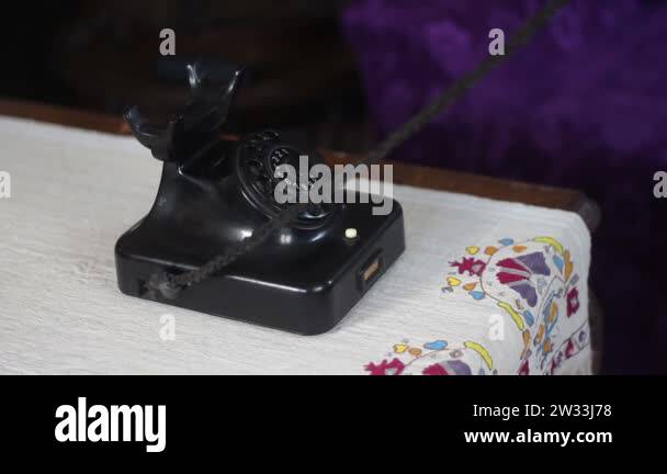 Dialing with an retro rotary phone, woman in the office dials the old ...