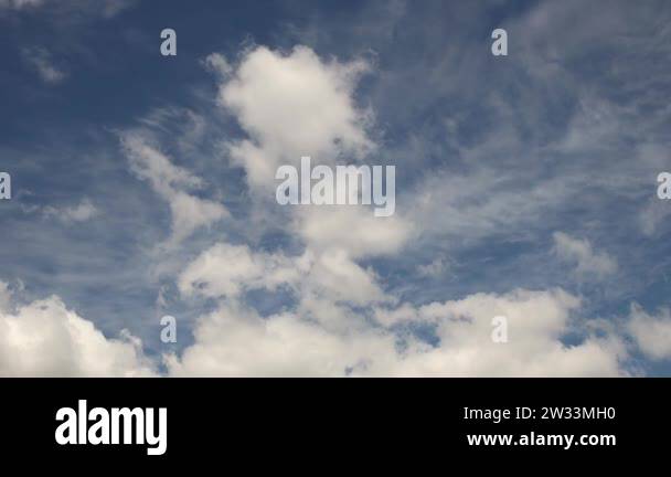 Clear blue sky with cumulus clouds that stand still and cirrus clouds ...