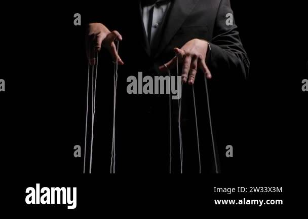 Puppeteer pulls the doll strings tied to his fingers. Puppet rope ...