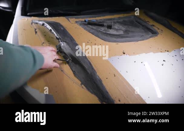 designer is making form of car hood for tuning service, covering ...
