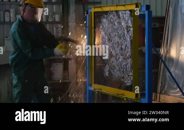 Worker in Uniform And Protective Screen is Beating the Glass Sheet with ...