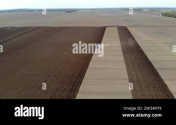 aero. Tractor with special trailer plows land, soil, makes on soil ...