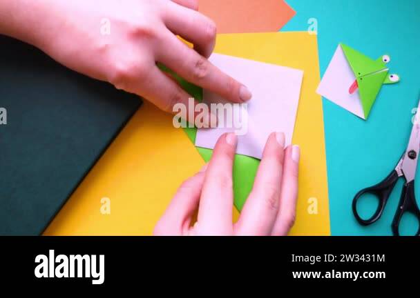 Step 3. female hands make paper bookmark. Step-by-step instructions on ...