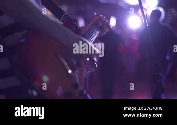 Guitarist play guitar with a pick, long fingers on fretboard under ...