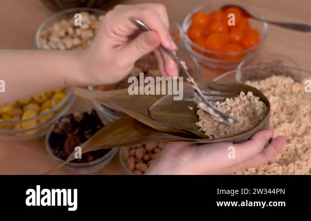 Making zongzi - family preparing, wrapping bunch of Chinese rice ...