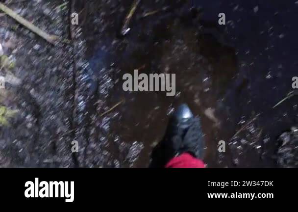 the feet of a man in rubber boots walk through the mud Stock Video ...