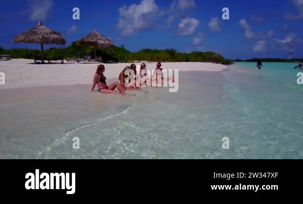 video the tan girls in bikini lying on the white sandy beach and ...