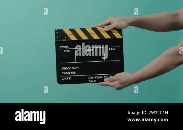 Movie Clapperboard. Film crew man hand hold and clap empty black and ...
