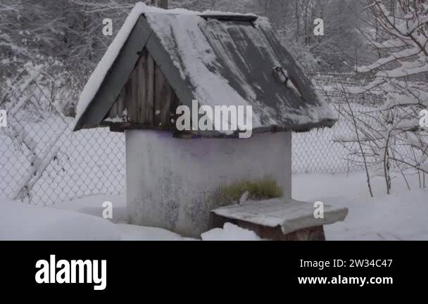 Ancient village well in winter during snowfall, well for water ...