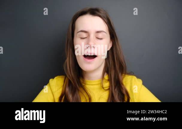 Lovely young woman with happy serene face pretends sleeping, leans on ...