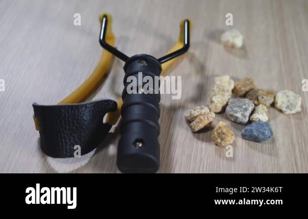 Stone and rock with slingshot small hand-powered projectile weapon ...
