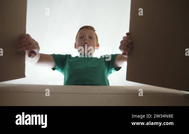 Child opening box with gift and pulling hands to take it. Little boy ...