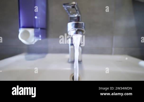 Steam from hot water in the sink. Hot tap water. Warm water flows from ...