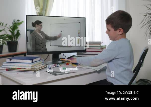 online education, male student at home school watching a video ...