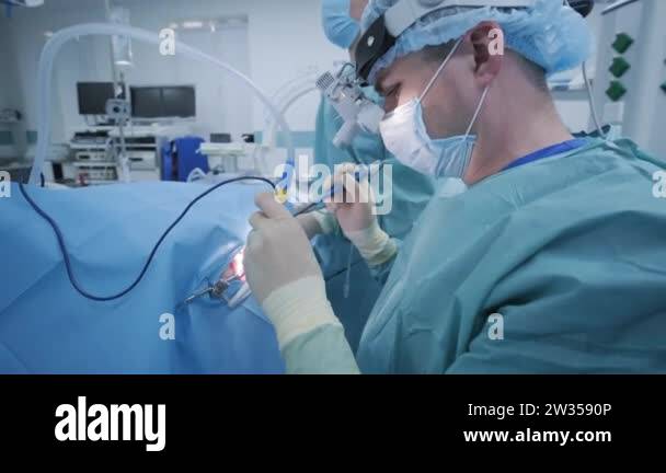 Operation of removing tonsils under deep anesthesia, surgeon uses ...