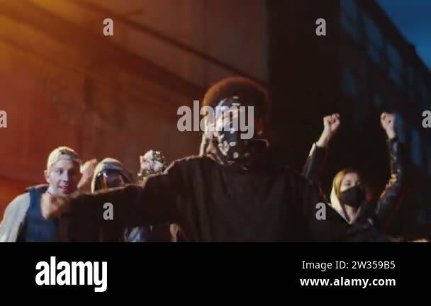 Mixed-races young people screaming mottos against racism and violence ...