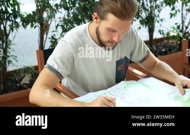 Young man map Stock Videos & Footage - HD and 4K Video Clips - Alamy