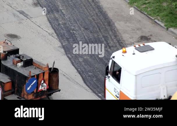 Special equipment spills old asphalt with bitumen for better bonding of ...