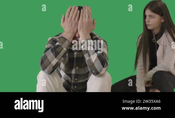 Surprised teenage girl looking at man rubbing eyes and crying and ...