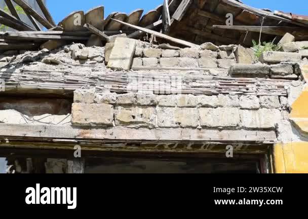 Remains of hurricane or earthquake disaster damage on ruined old house ...