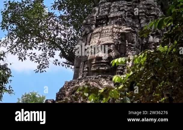 4K, Ancient stone faces statue of Ta Som temple. Angkor Thom is a ...