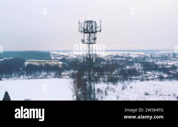 Snow falling at 5g antenna in slow motion. Telecommunication tower ...