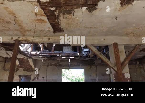 Collapsed roof of the total damaged domestic house indoor from natural ...