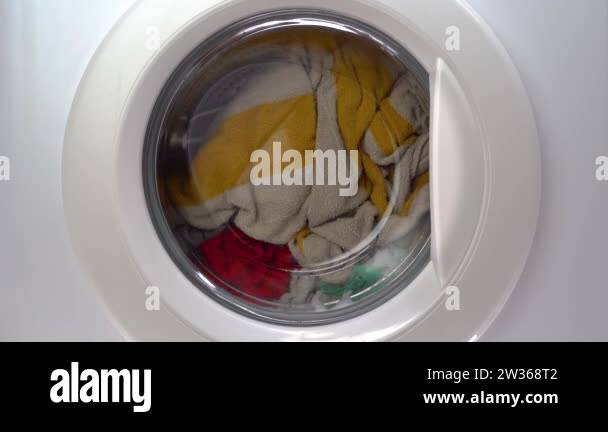 Washing machine is moving. Washing machine washes colored clothing and ...