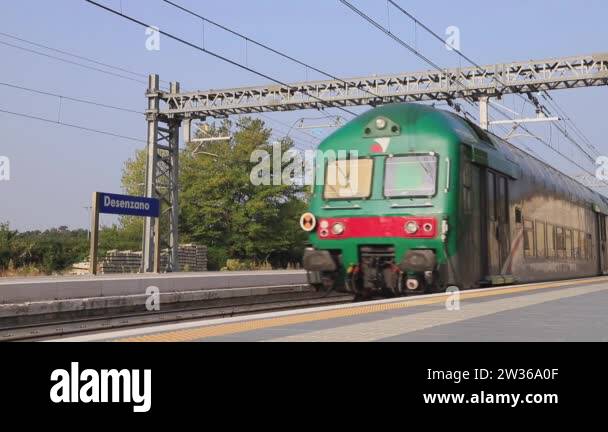 A Trenord passenger train arrives in Desenzano station. Trenord is a ...