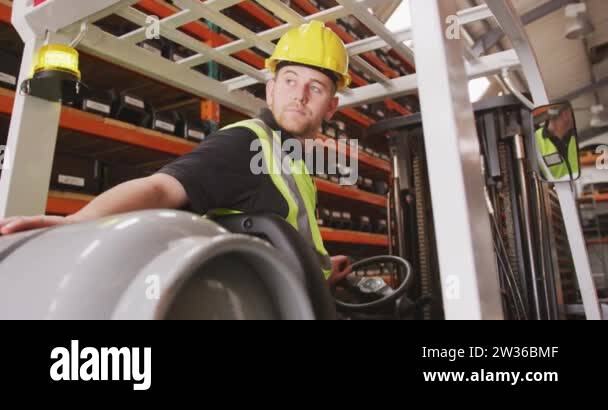 A Caucasian male factory worker at a factory making hydraulic equipment ...