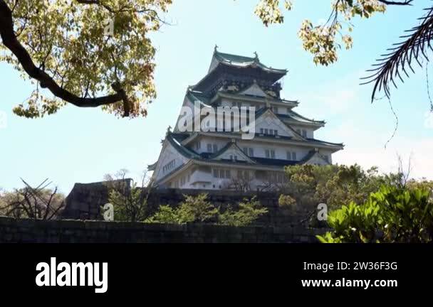 4K, Main tower of Osaka Japanese Castle behind rock wall, famous ...
