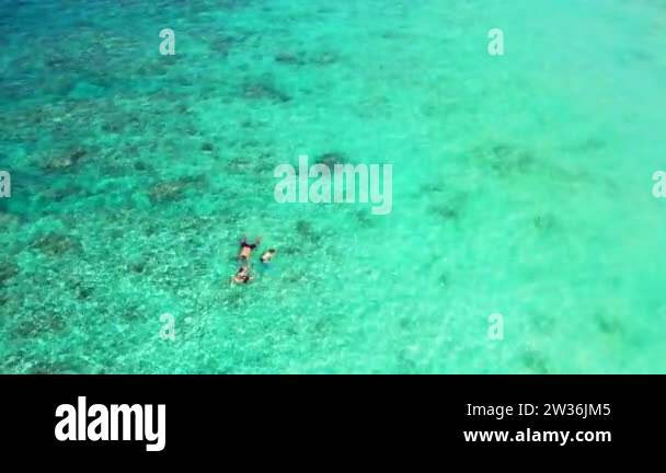 People snorkeling in transparent sea. Summer vacation scene in ...