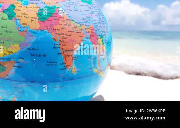 Earth globe placed on the beach. Tropical journey to Bali, Indonesia ...
