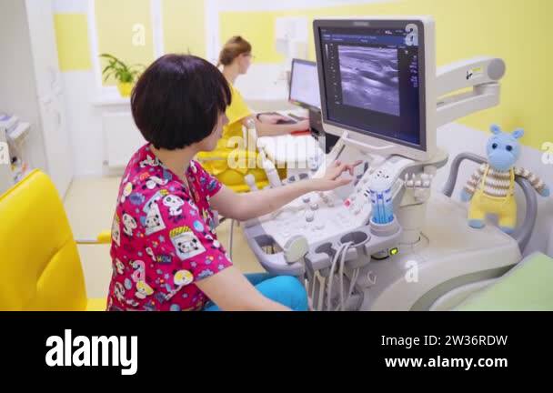 Female doctor makes ultrasound scanning diagnostic. Specialist woman ...