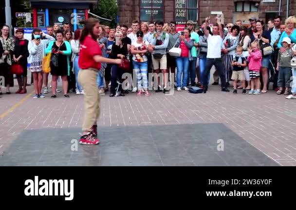 Young boys and girls are dancing on the street break dance among crowd ...