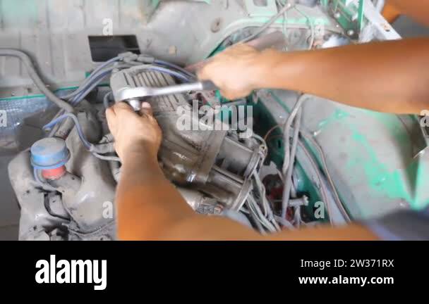 Professional mechanic fixing motor on old car using tool. Skillful ...