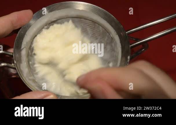 Pouring of Kefir. The mixture of fermented milk and granules is ...