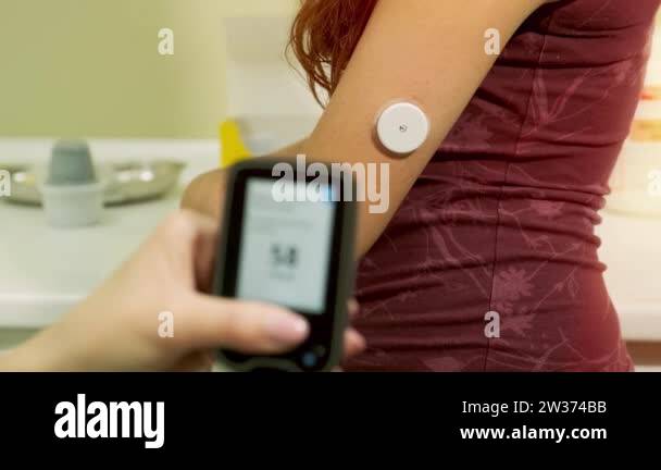 Doctor with an insulin pump connected in patient abdomen and holding ...