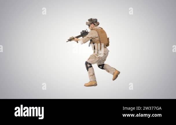 Soldier taking lying position and aiming at a target from automatic ...